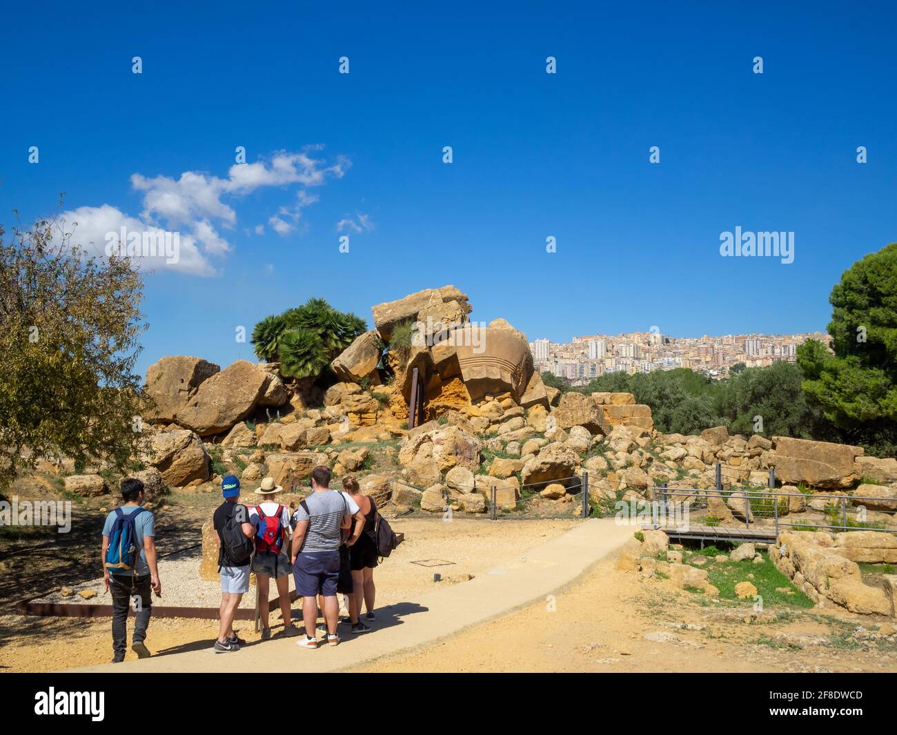 Tourists admiring the gigantic fallen columns of the Temple of Olympian ...