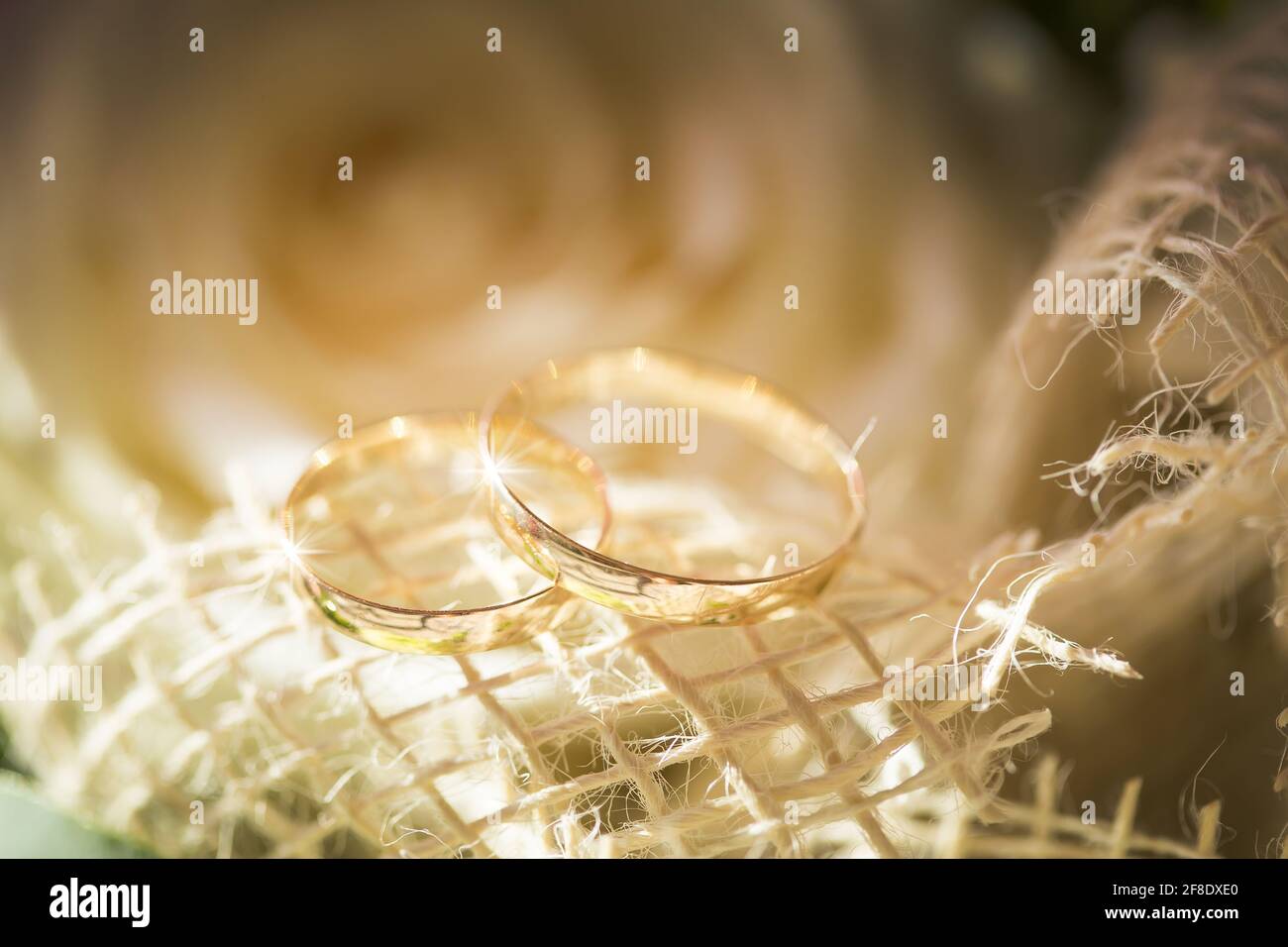 A pair of wedding rings on rope net background Stock Photo - Alamy