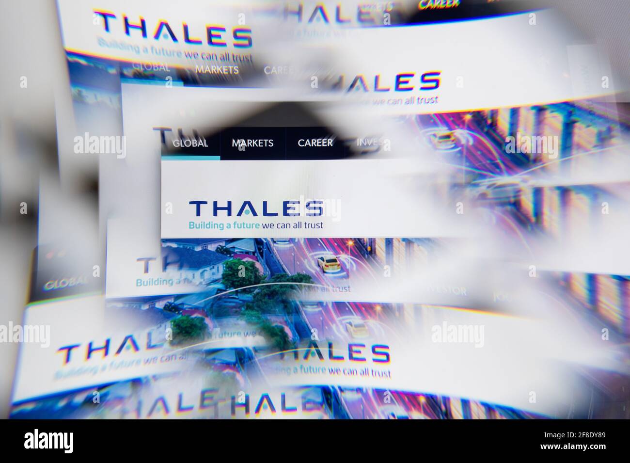 Milan, Italy - APRIL 10, 2021: Thales Group logo on laptop screen seen through an optical prism ...