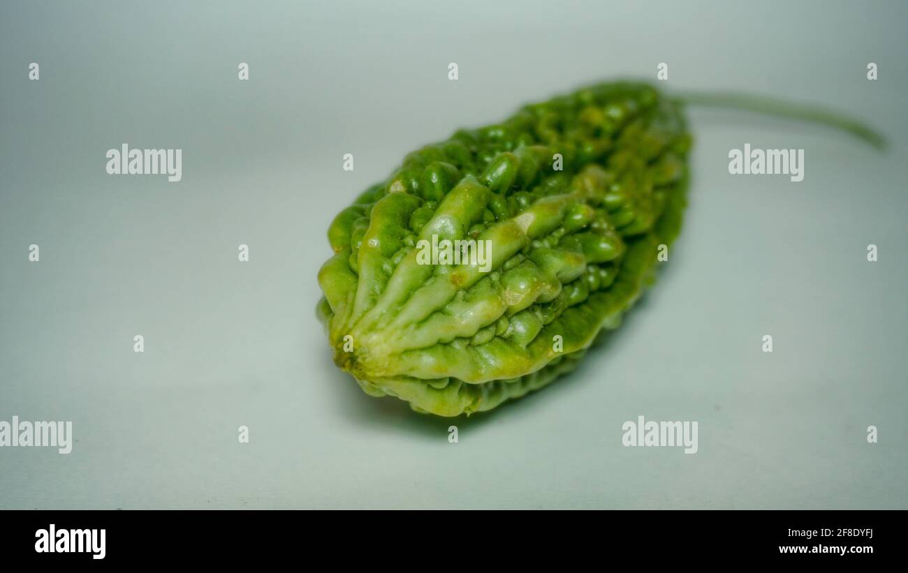 Fresh bitter melon on white. Healthy bitter melon for human body Stock ...