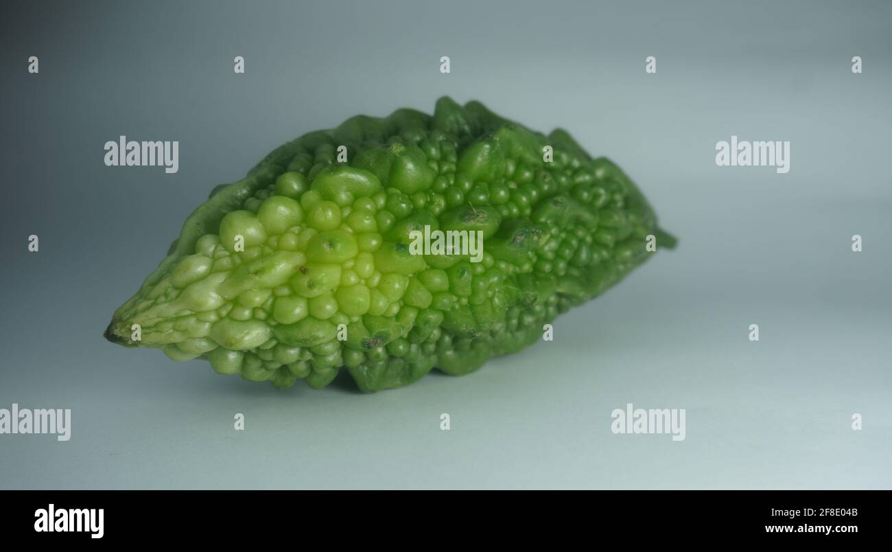 Fresh bitter melon on white. Healthy bitter melon for human body Stock ...