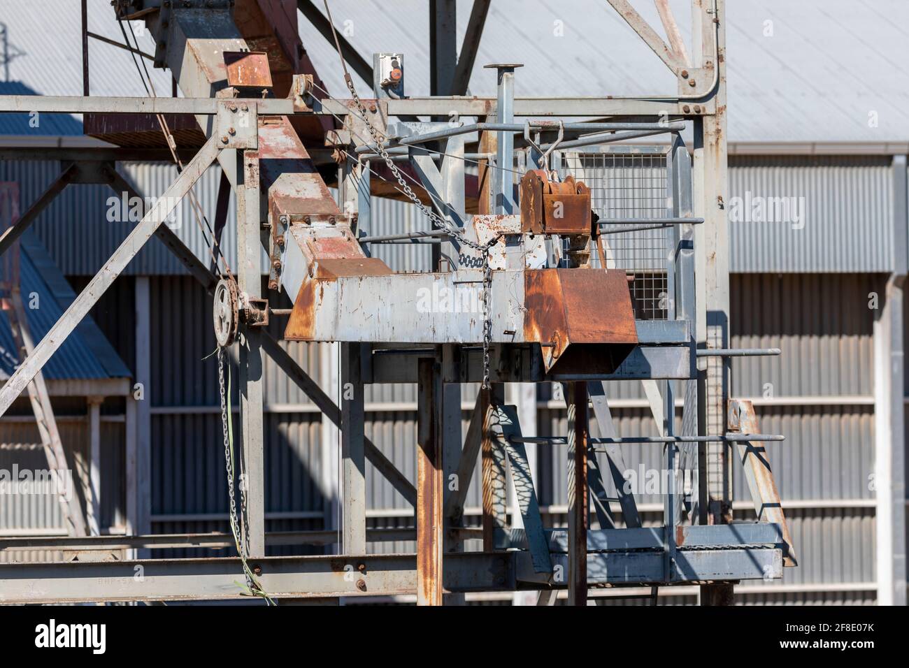 An old and rusty train loading conveyor system at a large flour mill ...