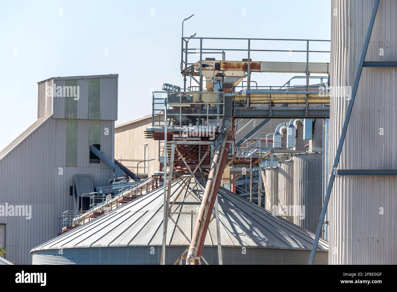 Production buildings and storage tanks and catwalk at a large flour ...