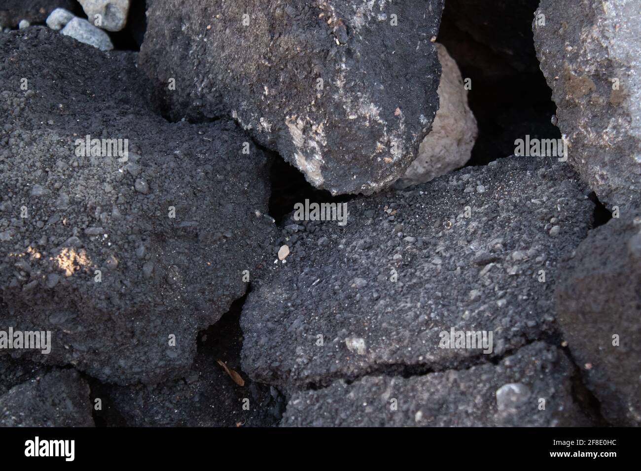 close-up of Old cracked asphalt pavement. concept of reduce reuse ...