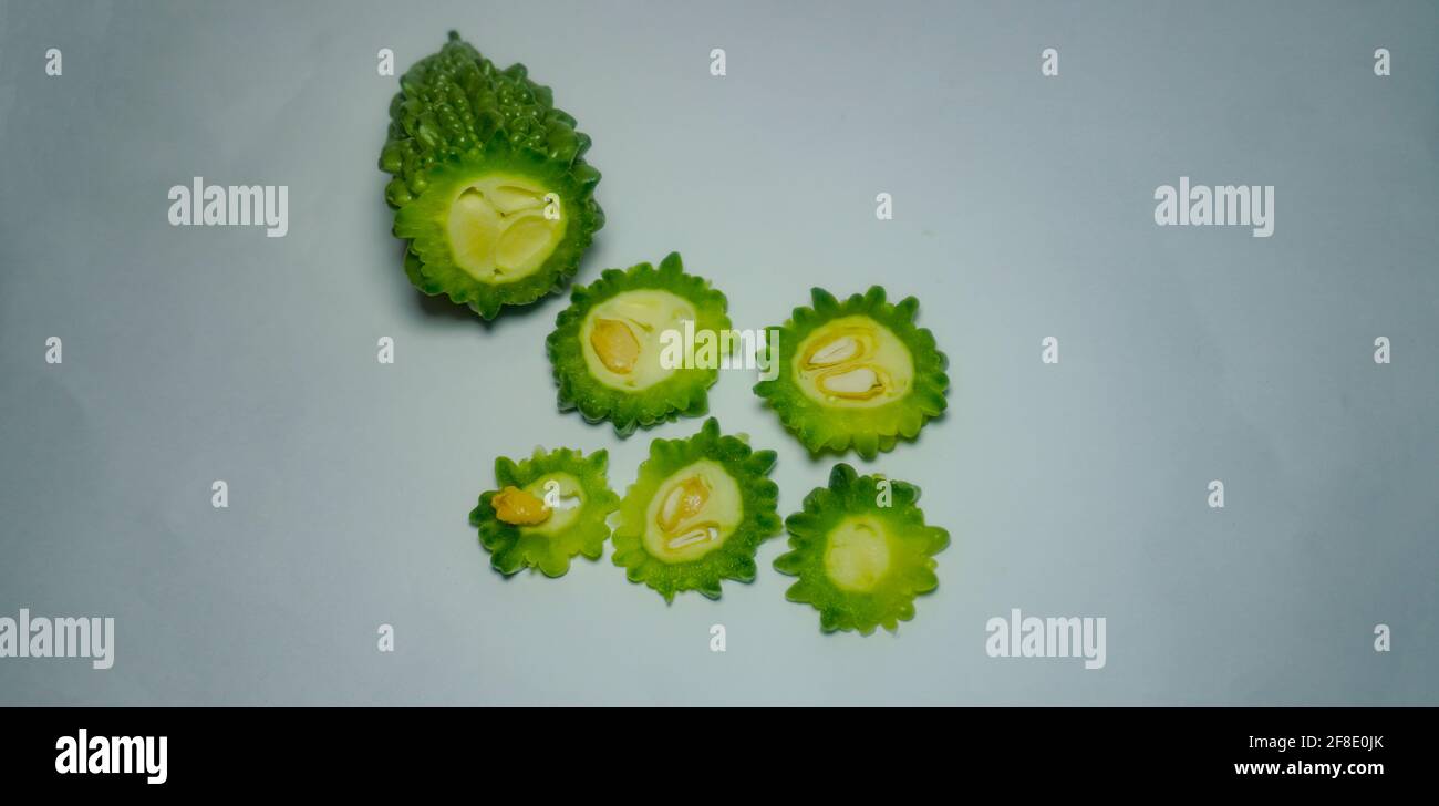 Fresh bitter melon on white. Healthy bitter melon for human body Stock ...
