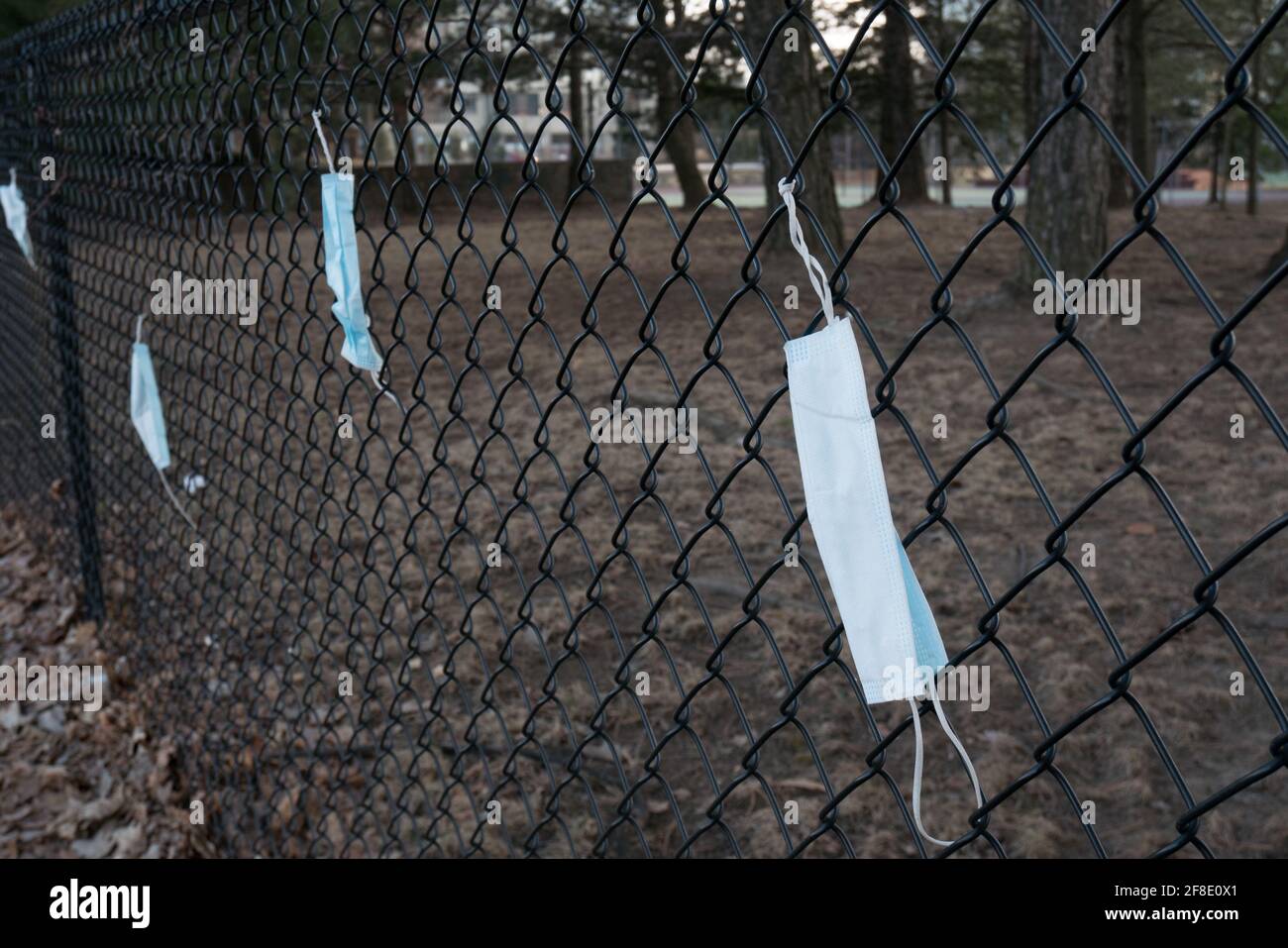 disposable mask hanging on a fence Stock Photo - Alamy