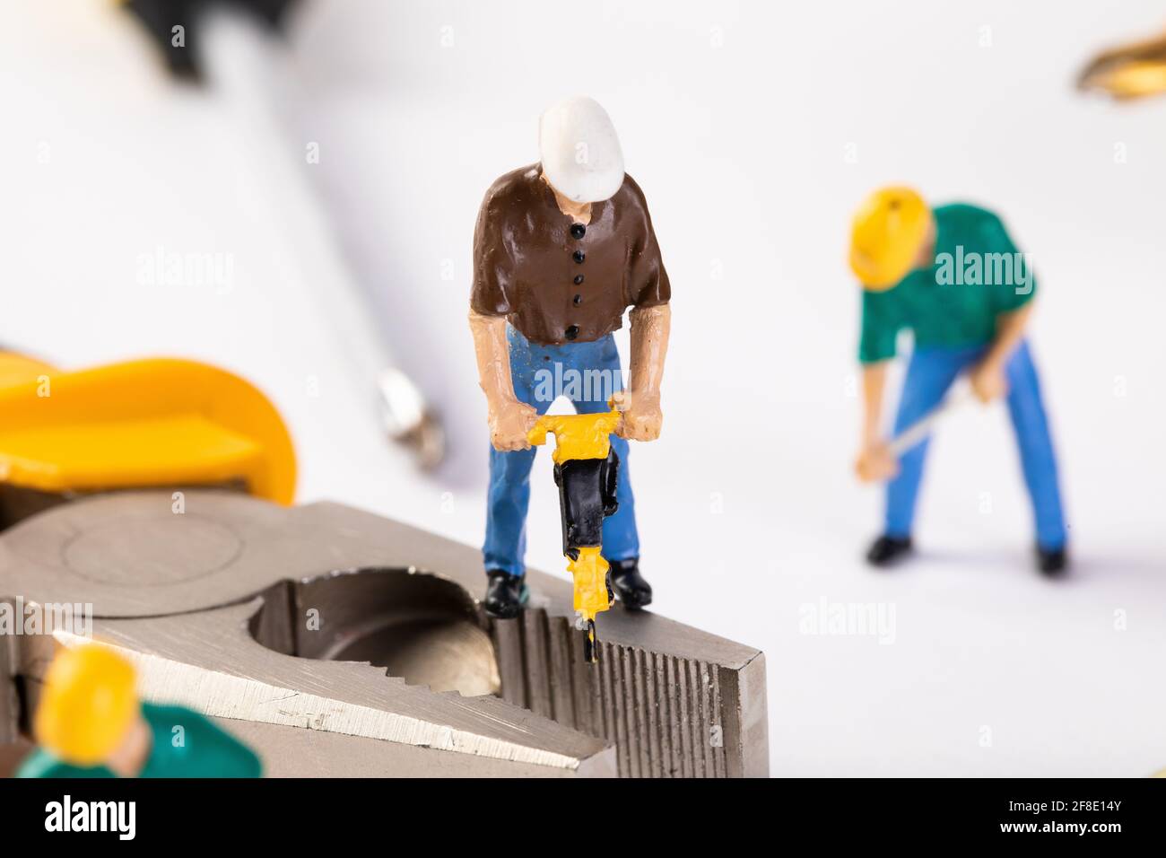 Closeup of construction worker miniatures on the repair tools on a ...