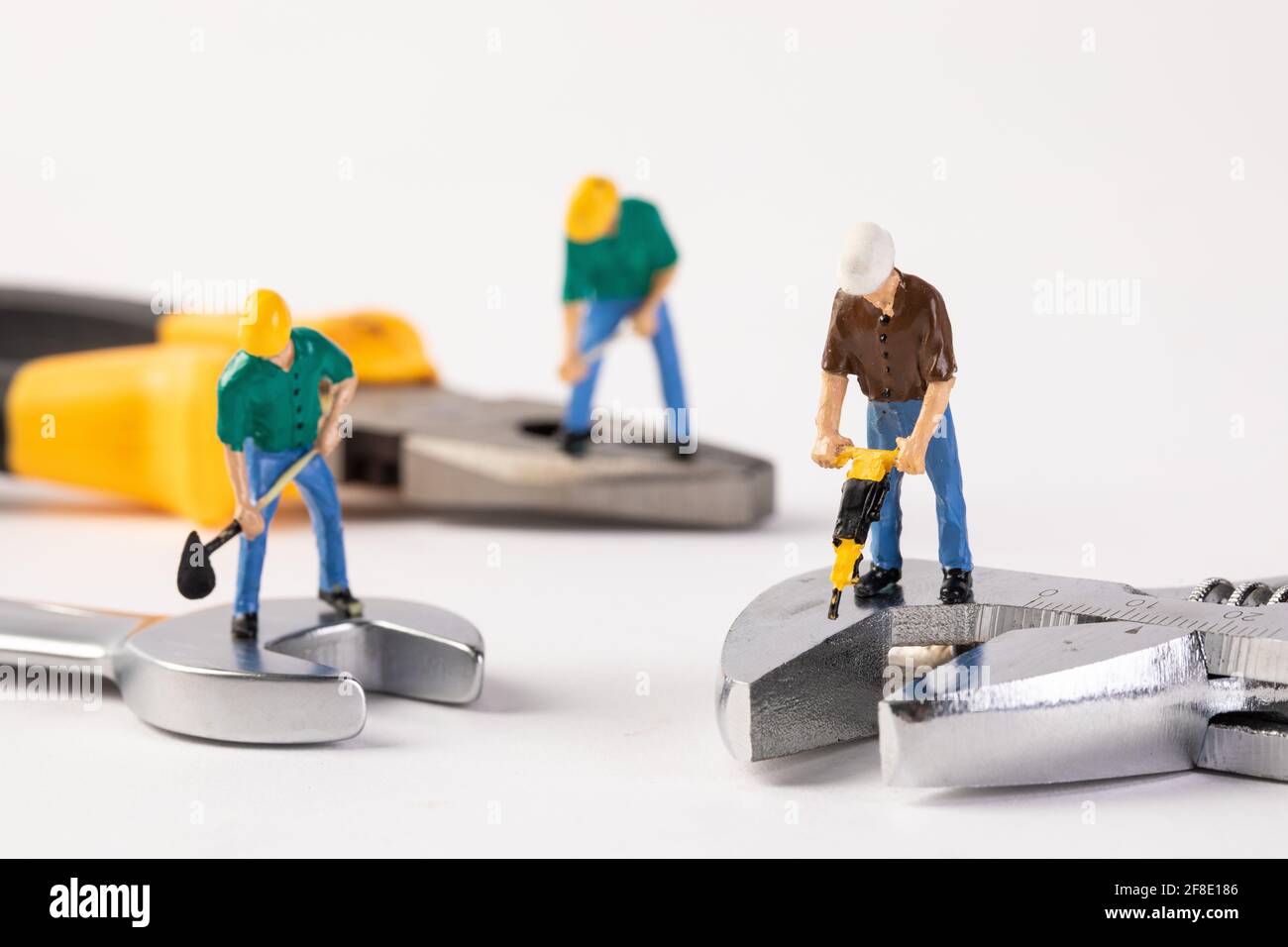 Closeup of construction worker miniatures on the repair tools on a ...