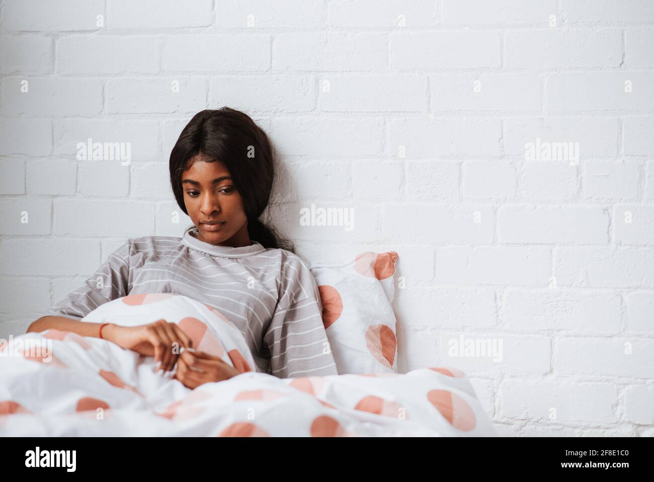Female leaning against bedroom wall hi-res stock photography and images ...