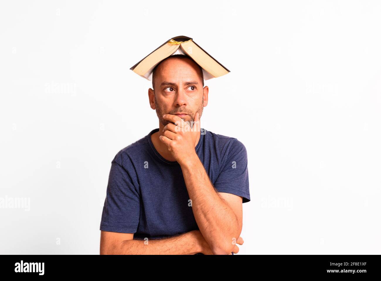 Funny man with an open book on his head thinks and has ideas Stock ...