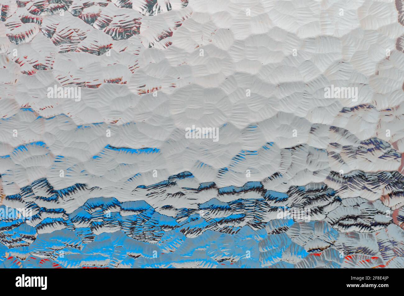 detail of a translucent glass with engravings reflecting the background ...
