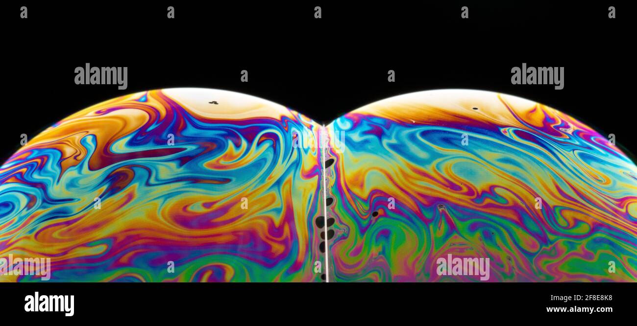 Bubble in rainbow colors isolated on a black background with space for ...