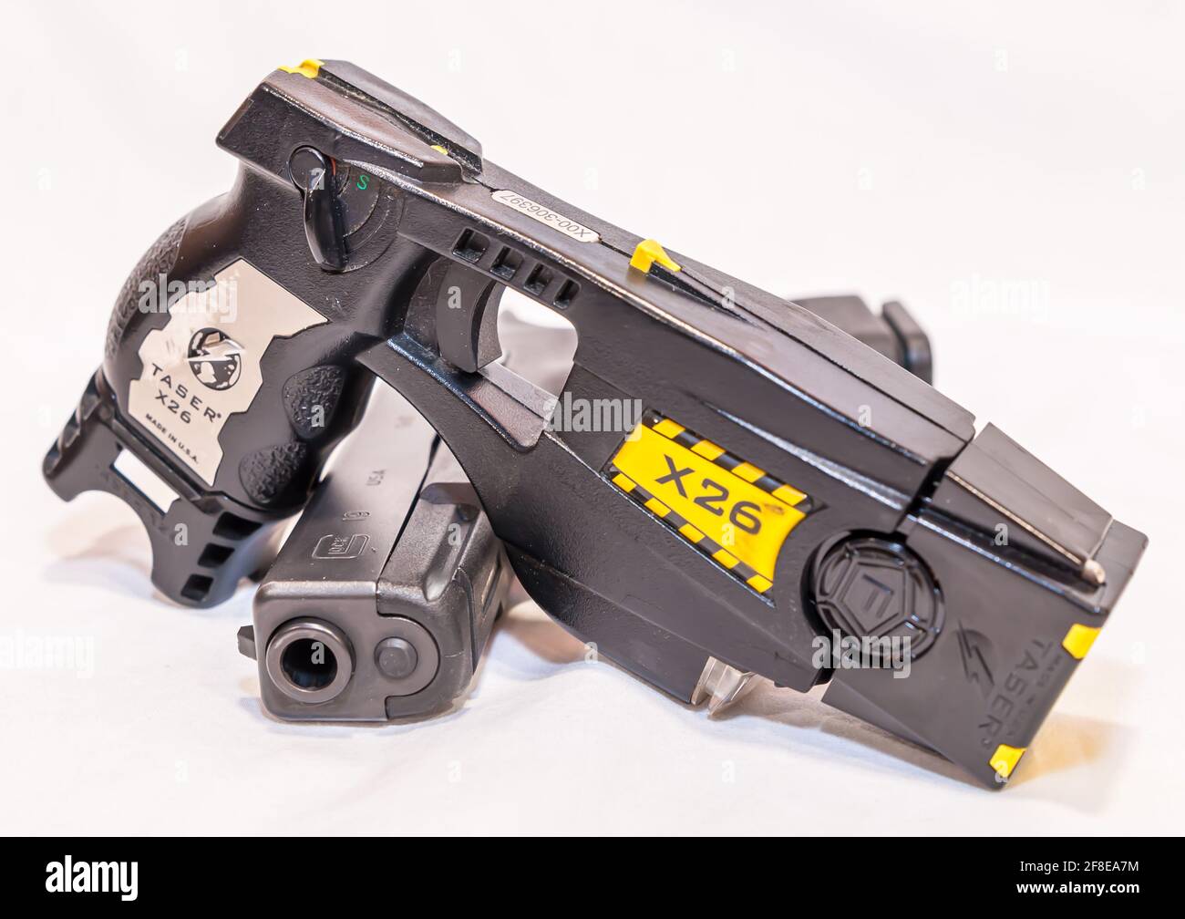 A black Glock 9mm pistol with a X26 Taser gun, both used by law ...