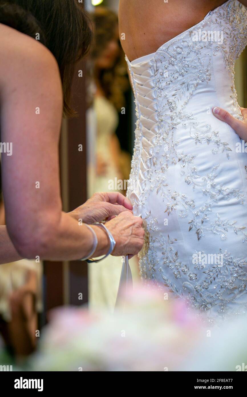 Women fitting a bride's dress in preparation for her wedding Stock ...