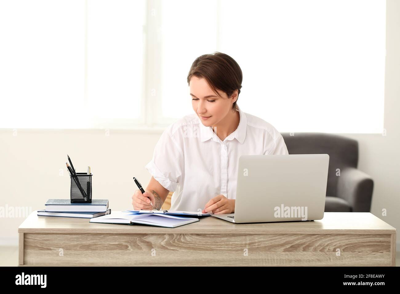 Female psychologist working in office Stock Photo - Alamy