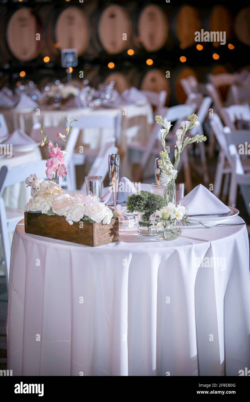 Elegantly set tables for an evening dinner wedding ceremony with ...