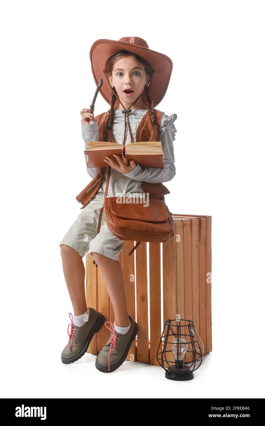 Cute little adventurer with book on white background Stock Photo - Alamy