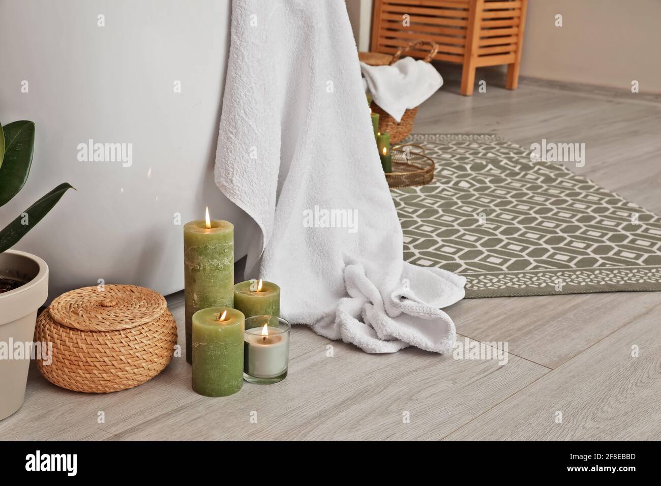 Burning candles on floor in bathroom Stock Photo - Alamy