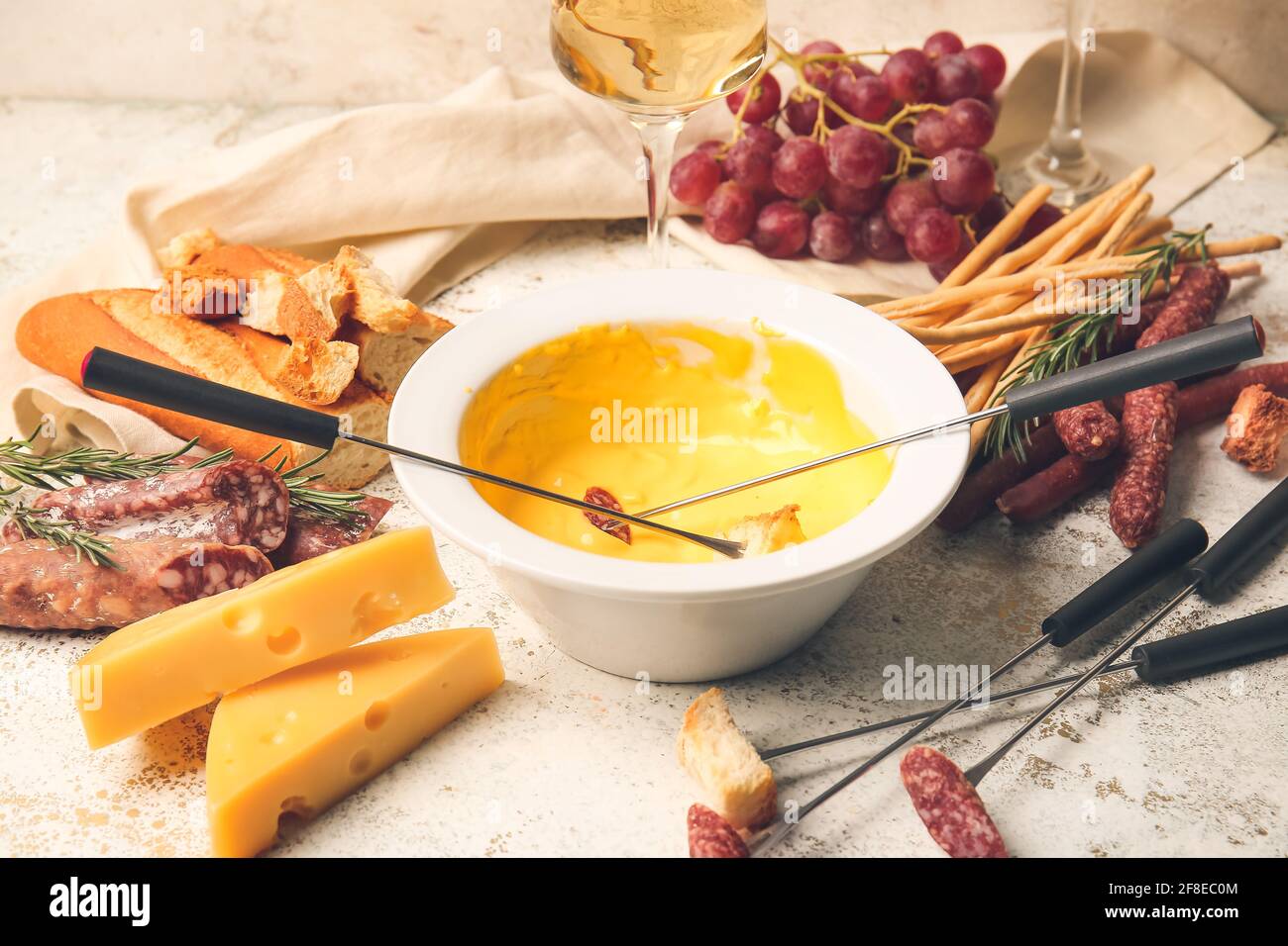 Cheese fondue and different snacks on light background Stock Photo - Alamy