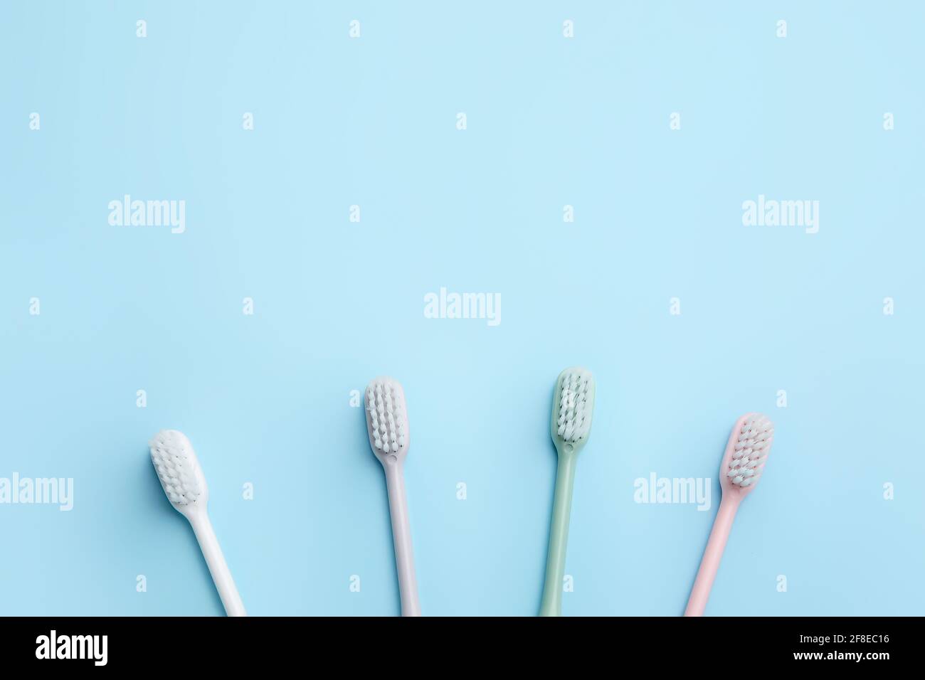Tooth brushes on color background Stock Photo - Alamy