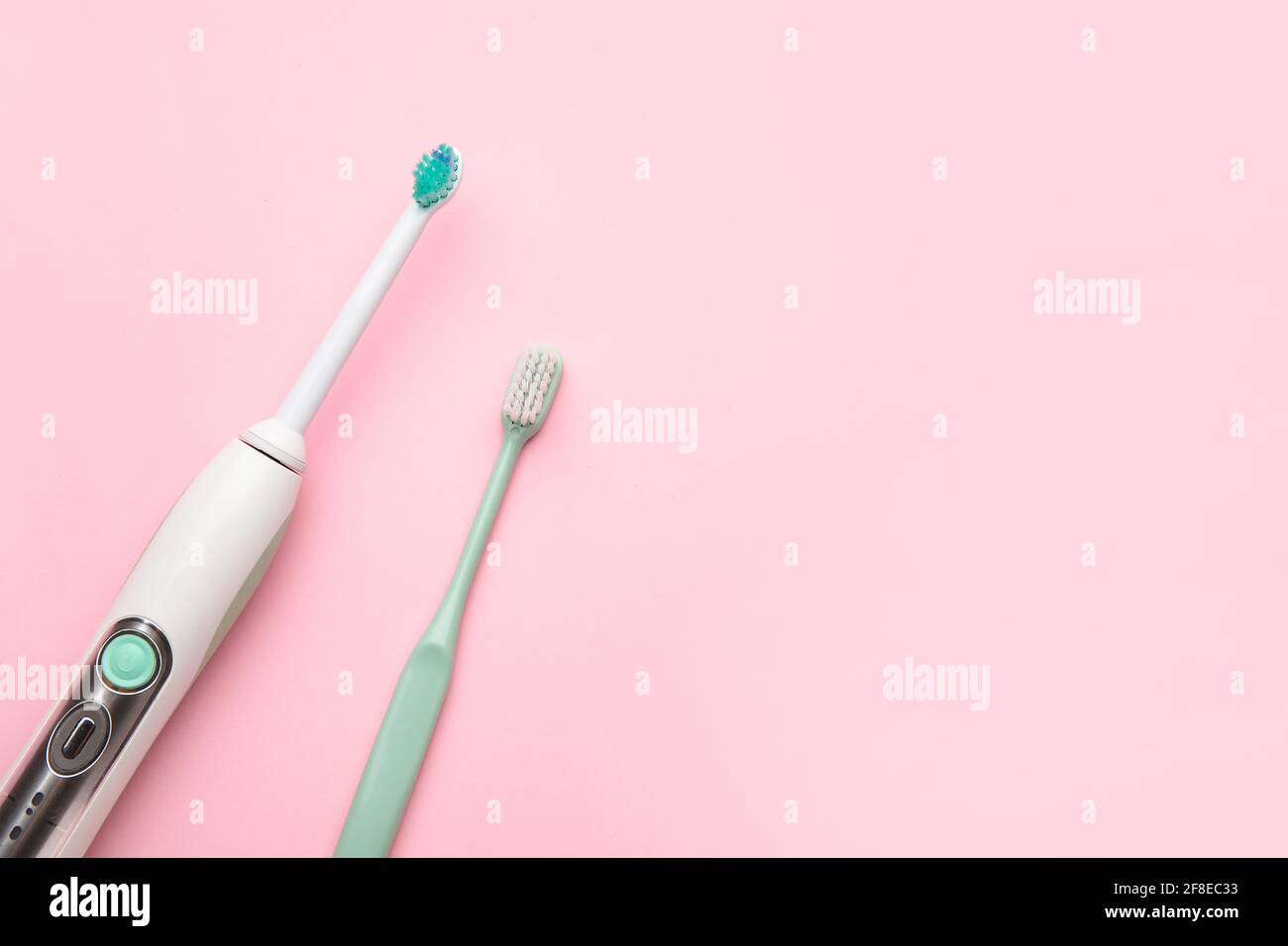 Different tooth brushes on color background Stock Photo - Alamy
