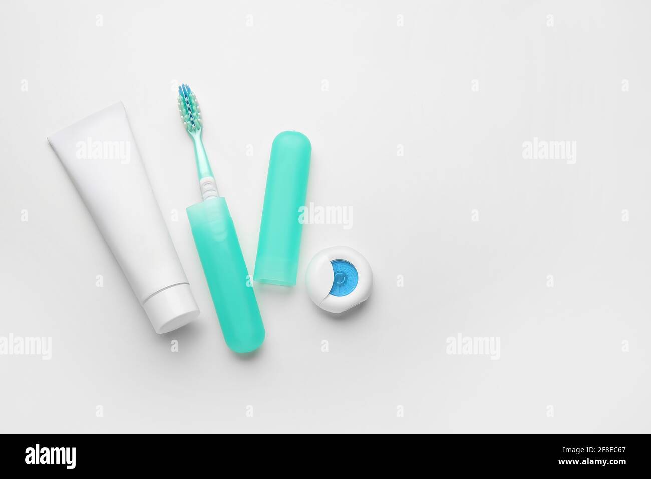 Tooth brush with case, paste and floss on white background Stock Photo ...