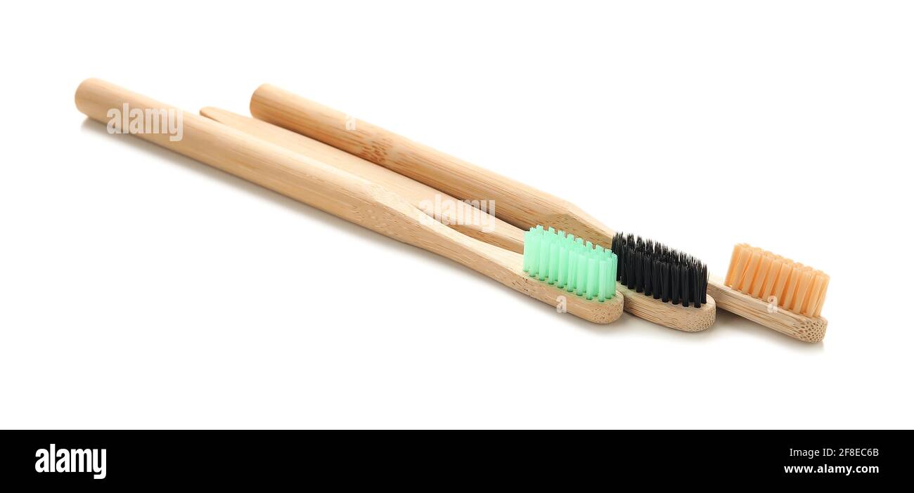 Wooden tooth brushes on white background Stock Photo - Alamy