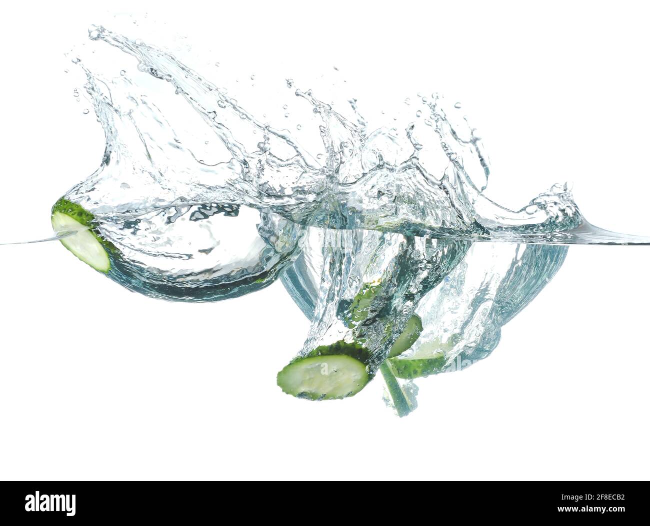 Falling of fresh cut cucumber into water against white background Stock ...