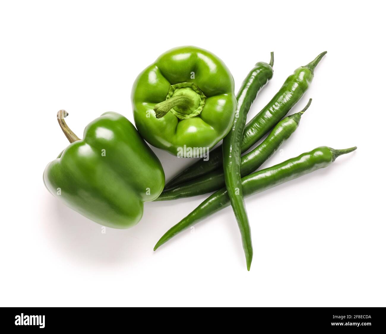 Green bell and chili peppers on white background Stock Photo - Alamy