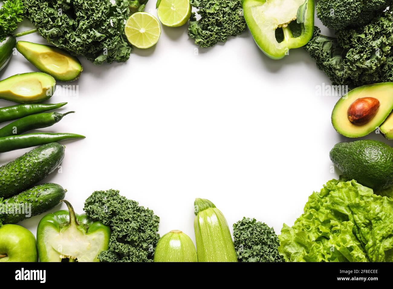 Frame made of fresh green vegetables on white background Stock Photo ...