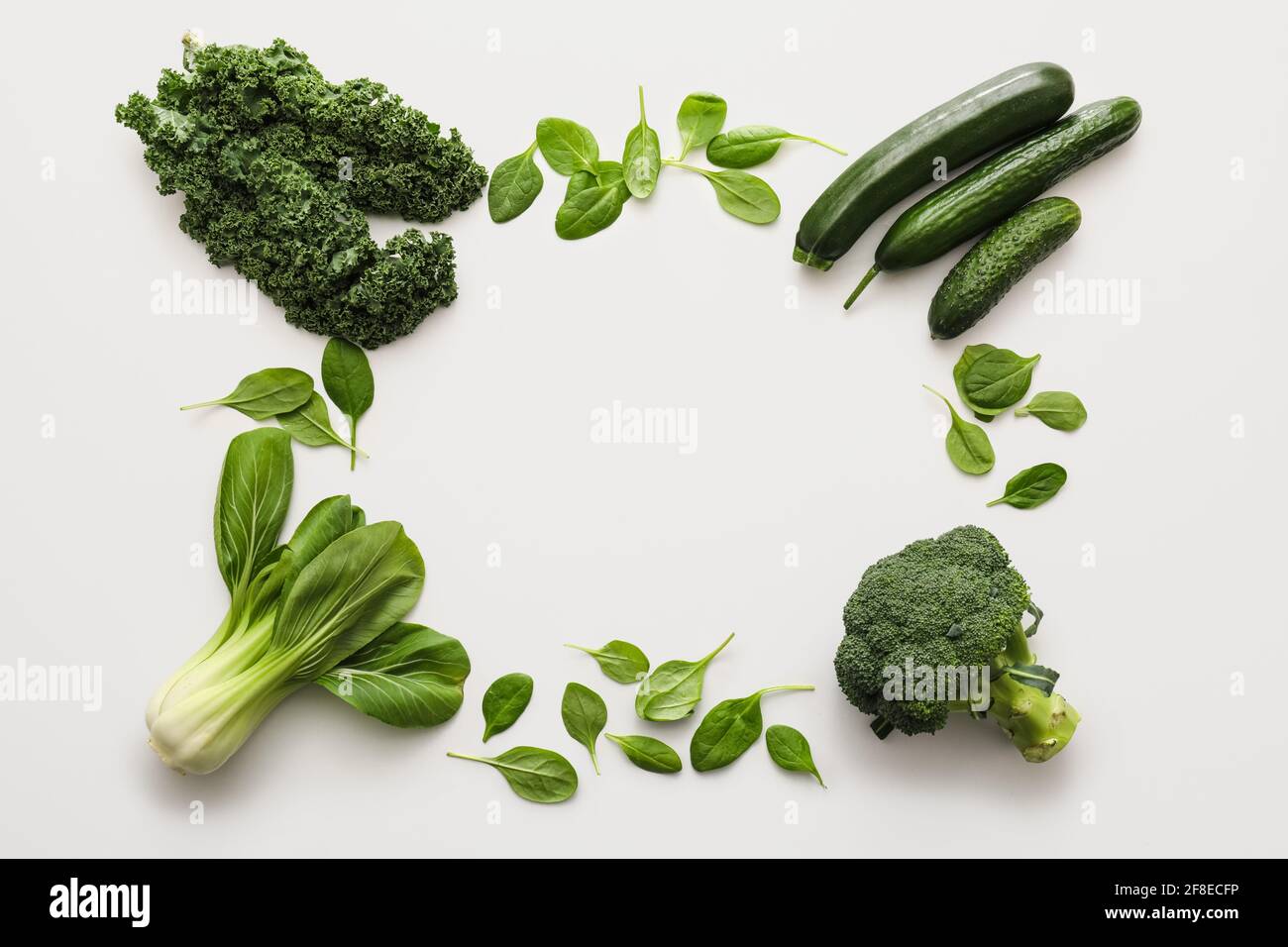 Frame made of fresh green vegetables on white background Stock Photo ...
