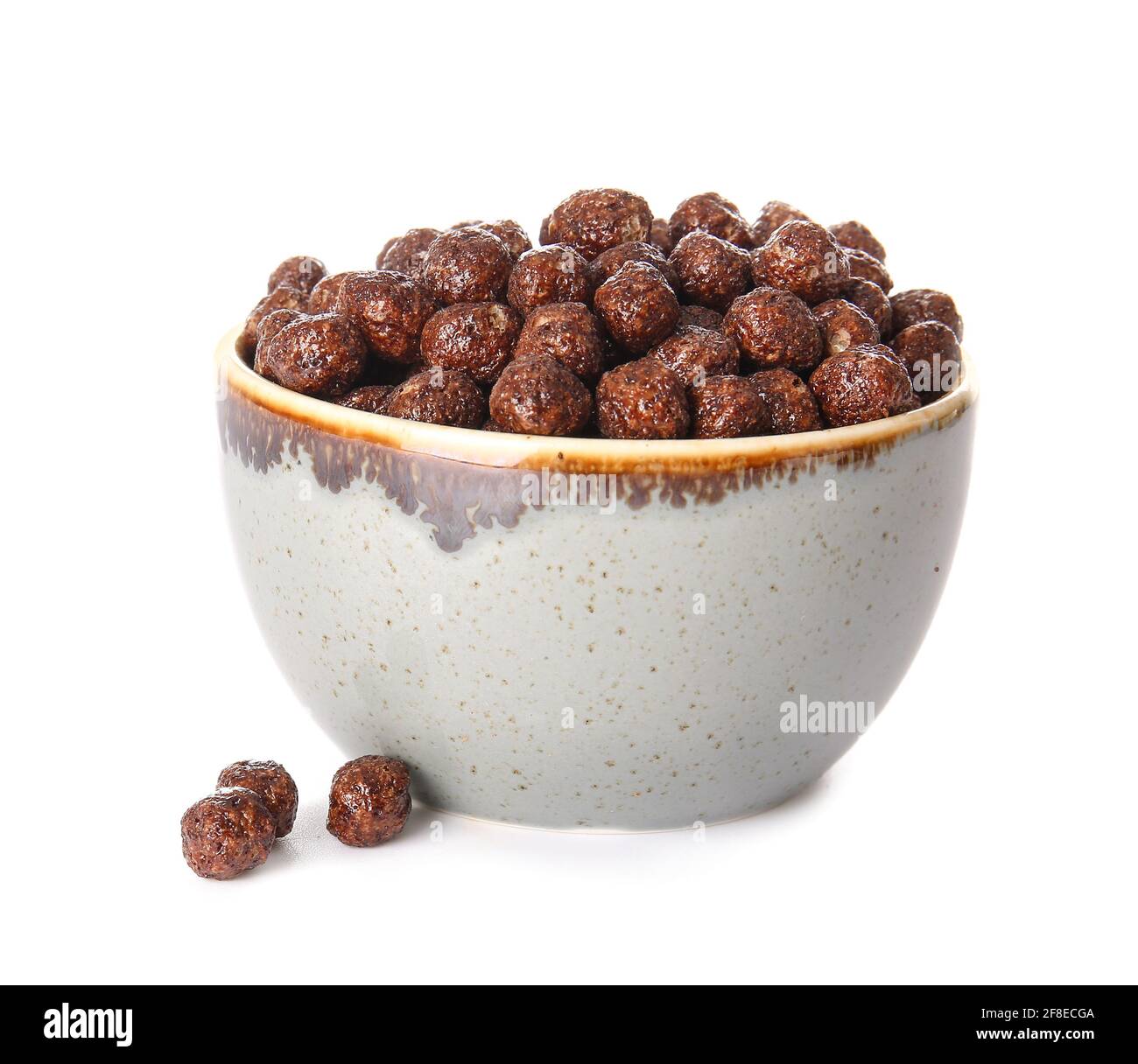 Bowl with chocolate corn balls on white background Stock Photo - Alamy