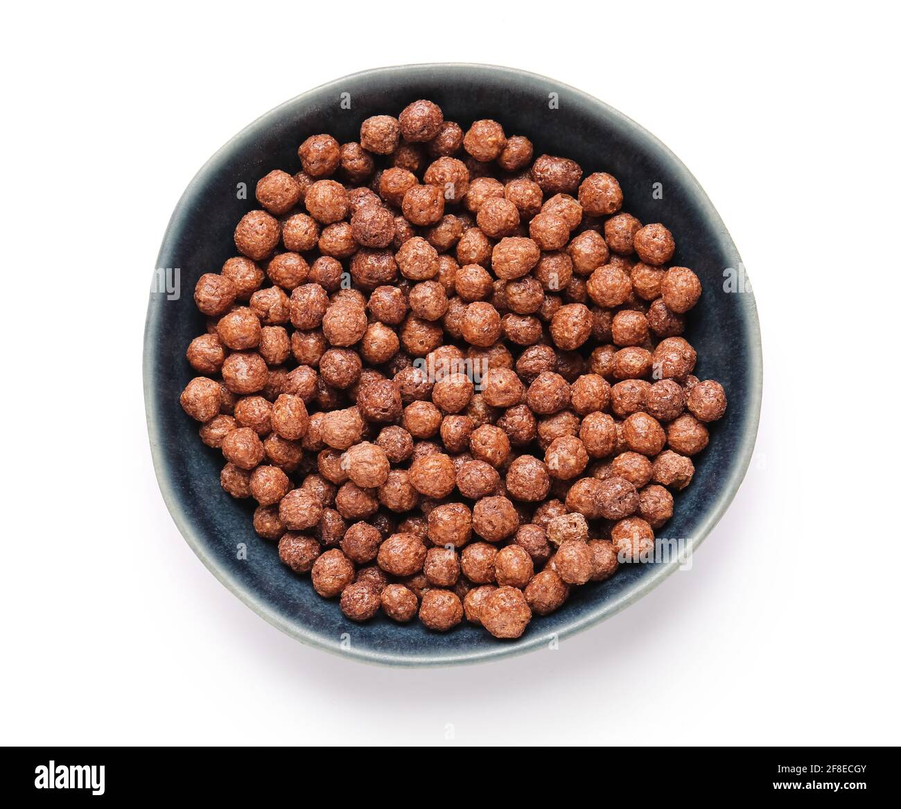 Bowl with chocolate corn balls on white background Stock Photo - Alamy