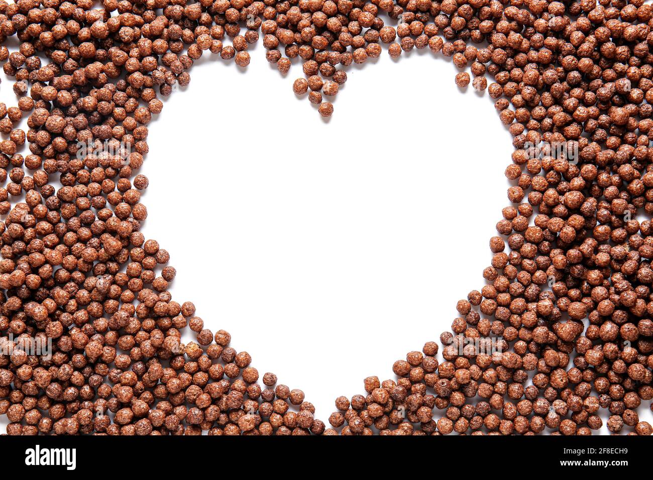 Heart shape made of chocolate corn balls on white background Stock ...