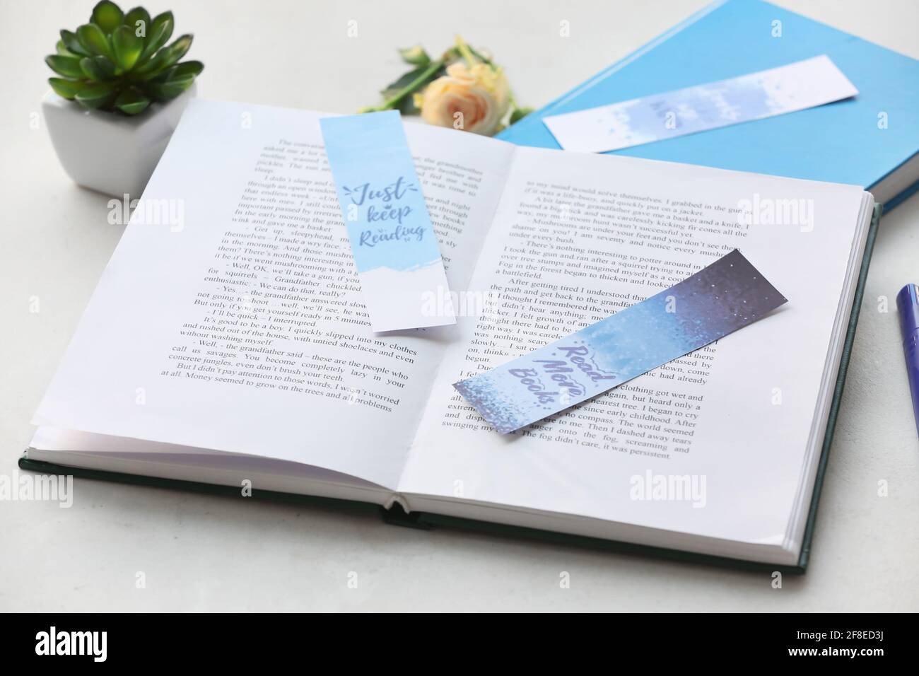 Books with bookmarks on light background Stock Photo - Alamy