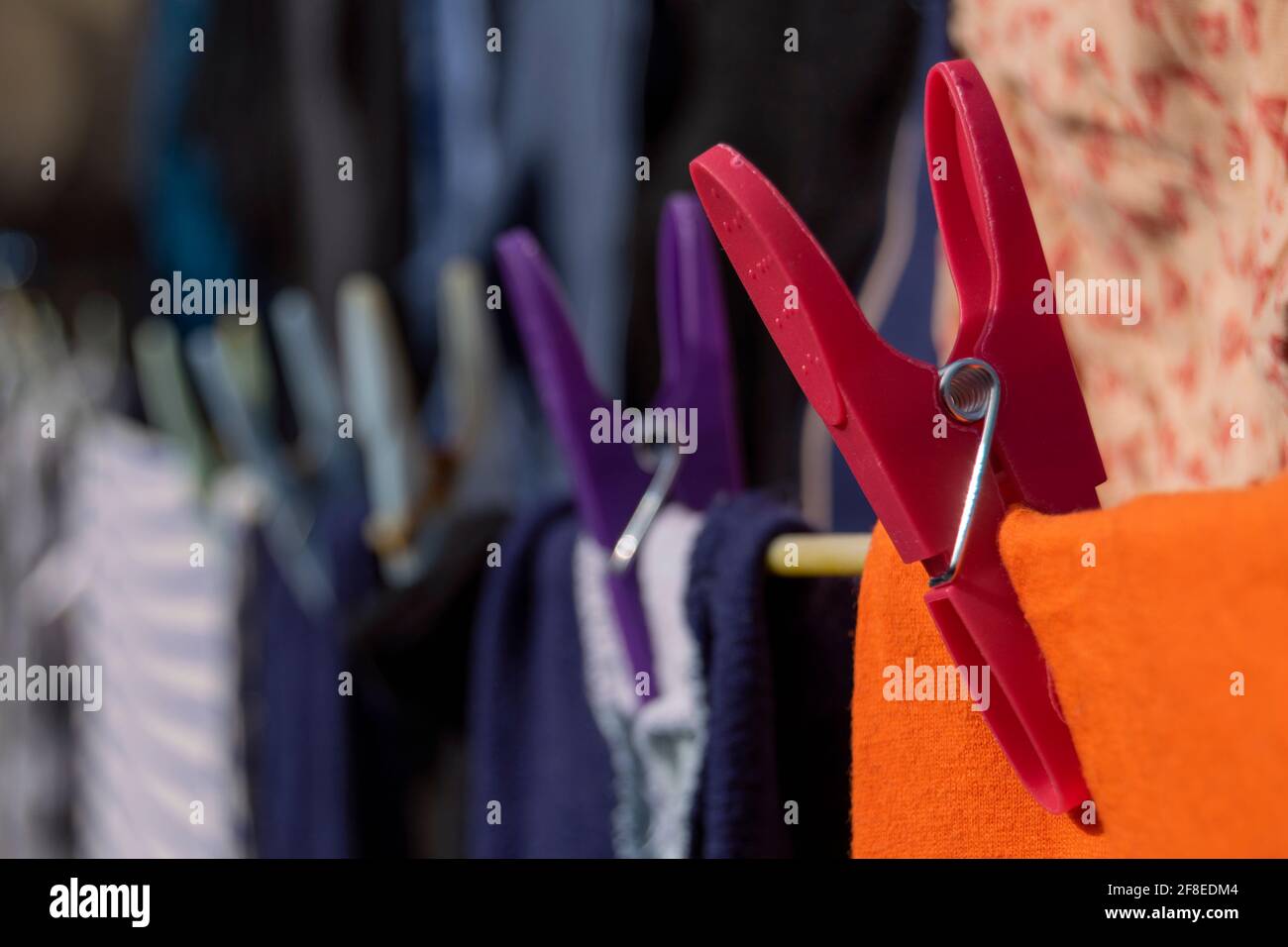 Peg holding clothes in washing line Stock Photo - Alamy