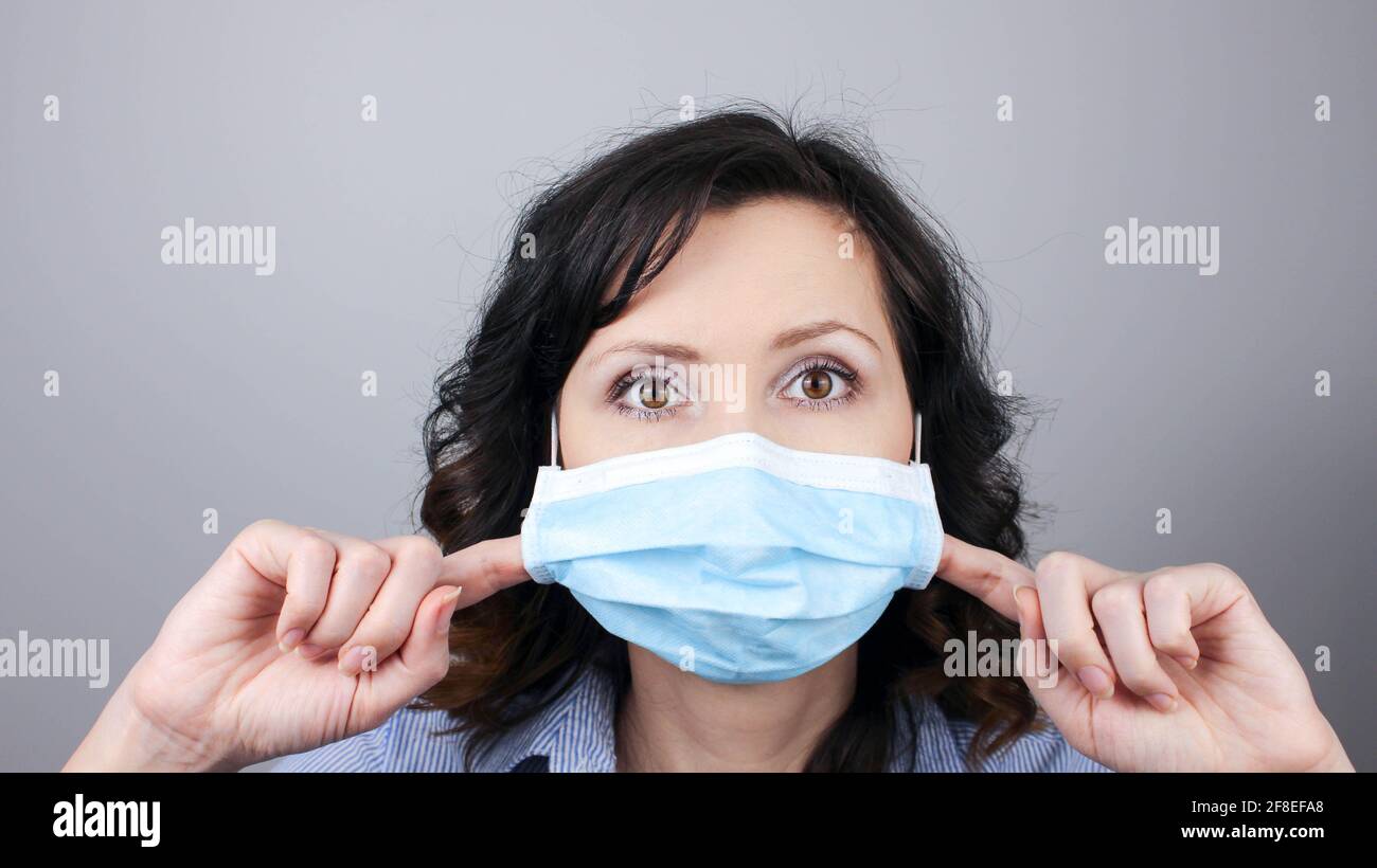 Woman removing medical face hi-res stock photography and images - Alamy