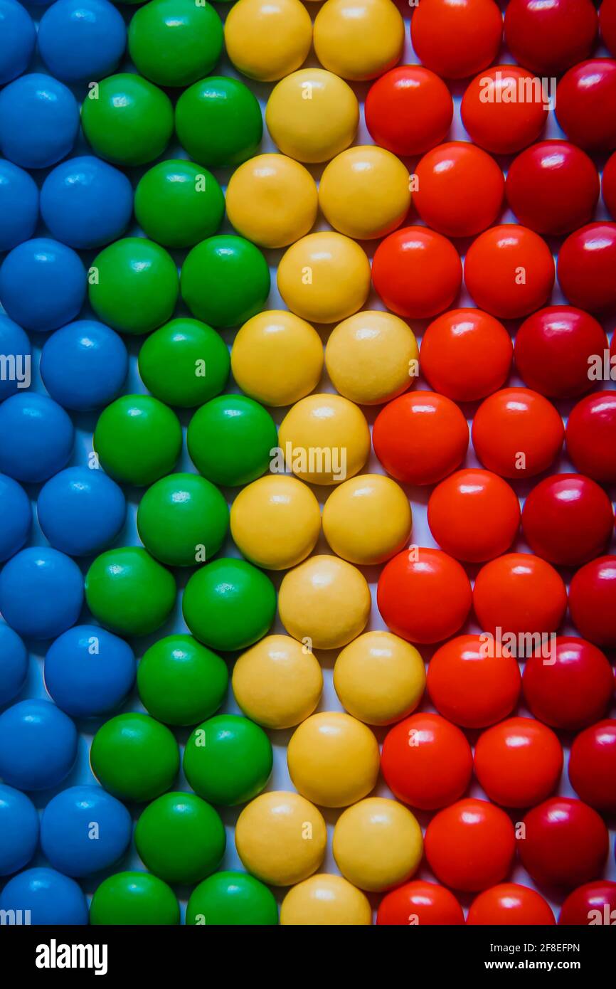 Brightly colored sweet candies laying flat. Rainbow candy background ...