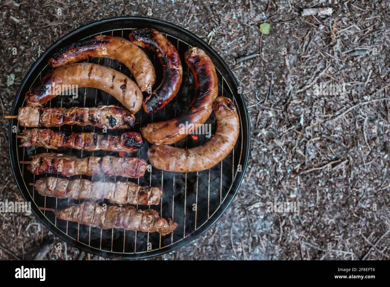 Barbeque meat and sausages on charcoal grill top view Stock Photo - Alamy