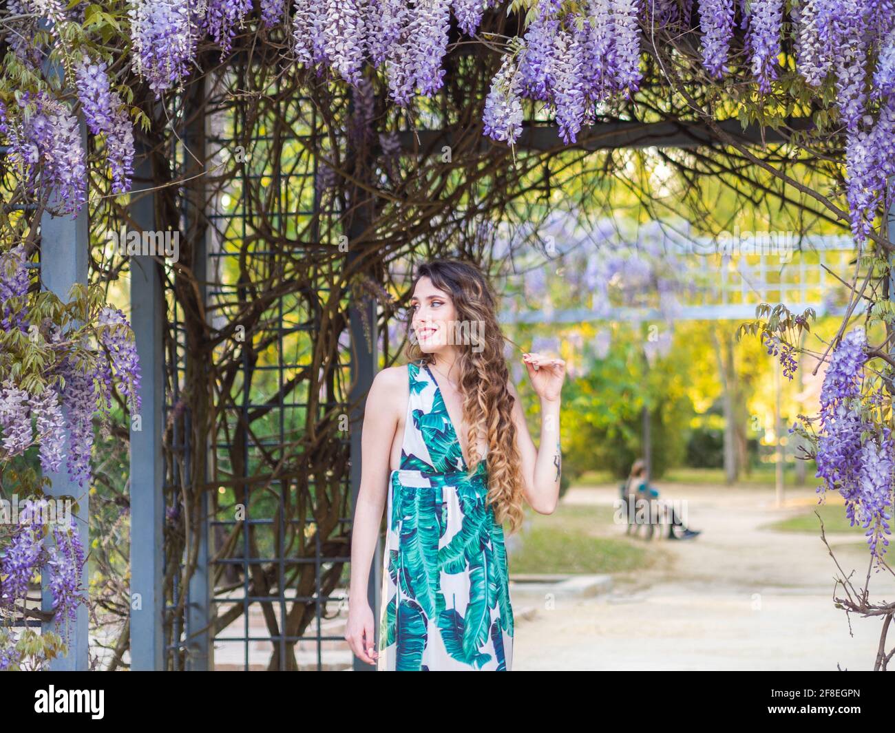 Attractive smiling Spanish lady with beautiful long hair is posing in ...