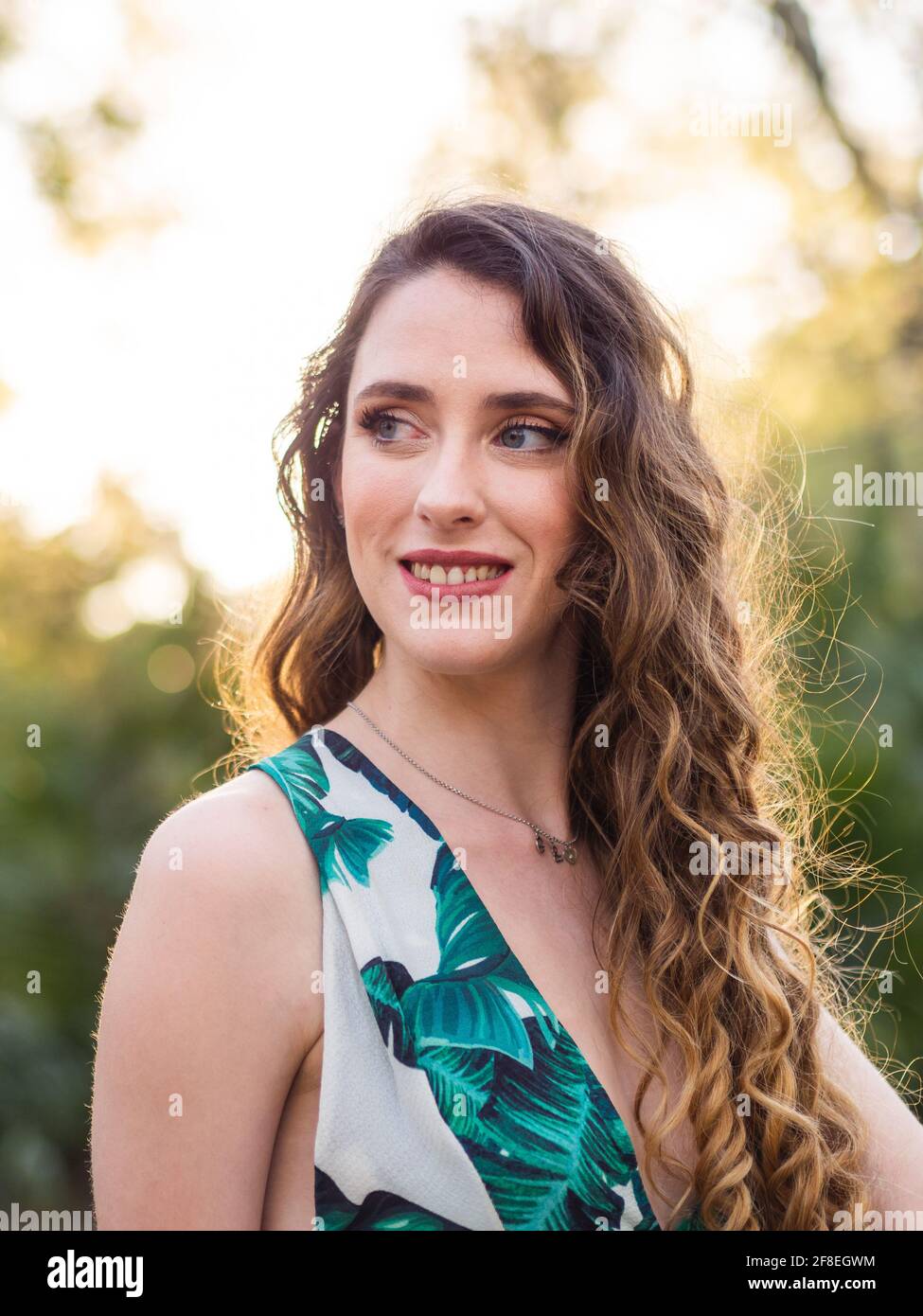 Portrait of a pretty young Spanish lady with long hair posing in the ...