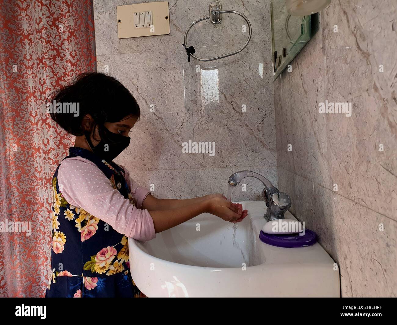 Washing hands in bathroom by masked Children during coronavirus ...