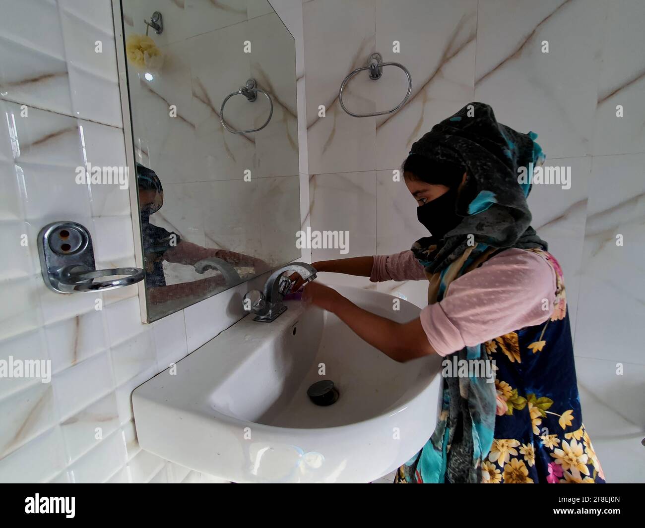 Washing hands in bathroom by masked Children during coronavirus ...