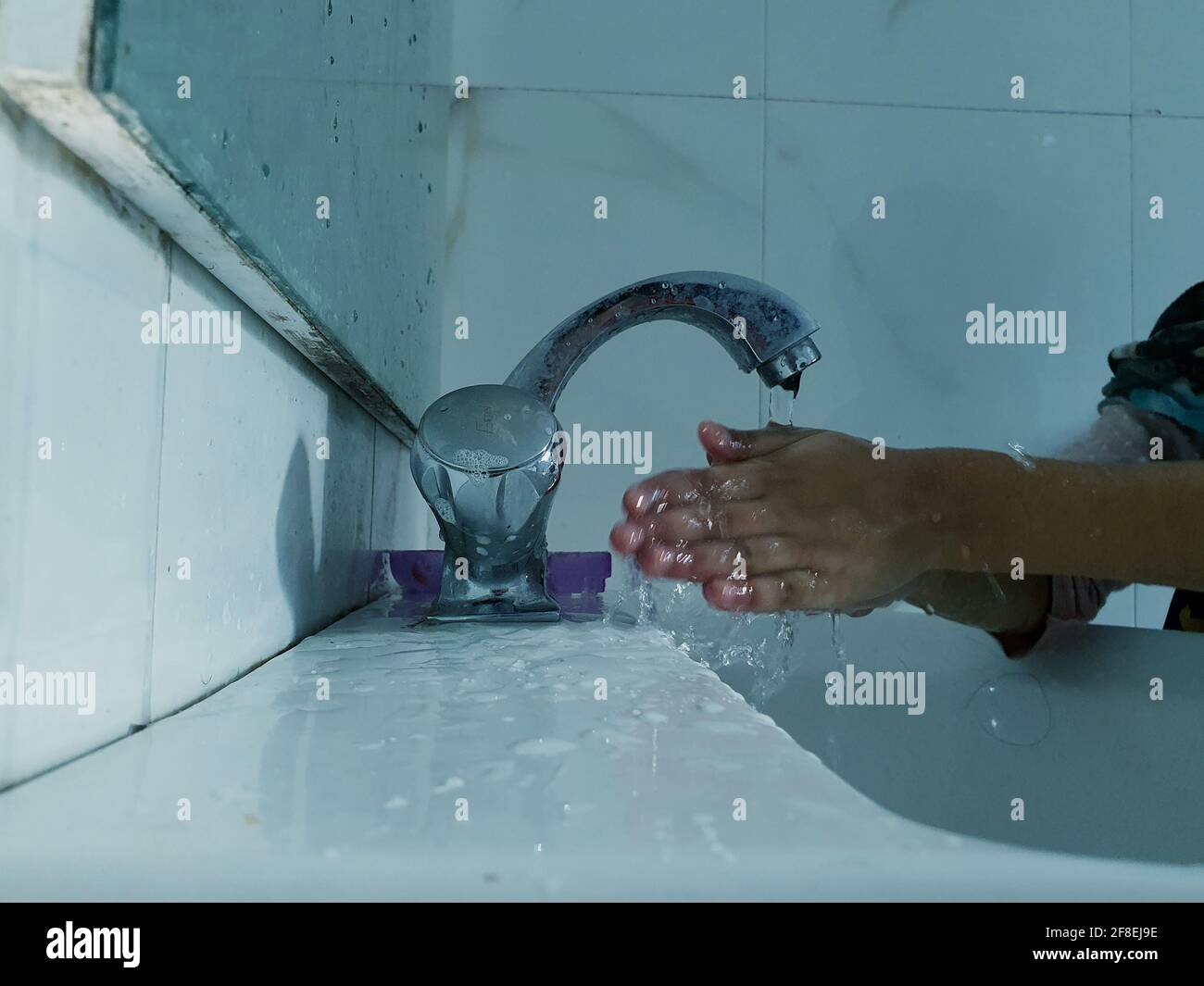 Masked Children washing hands during coronavirus pandemic. Hand wash ...