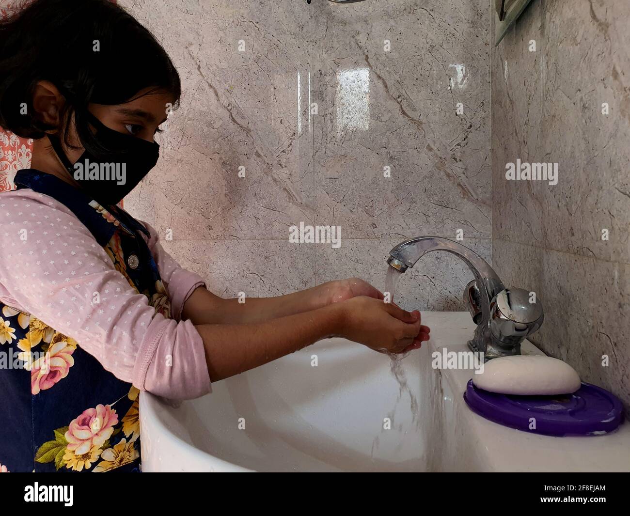 Washing hands in bathroom by masked Children during coronavirus ...