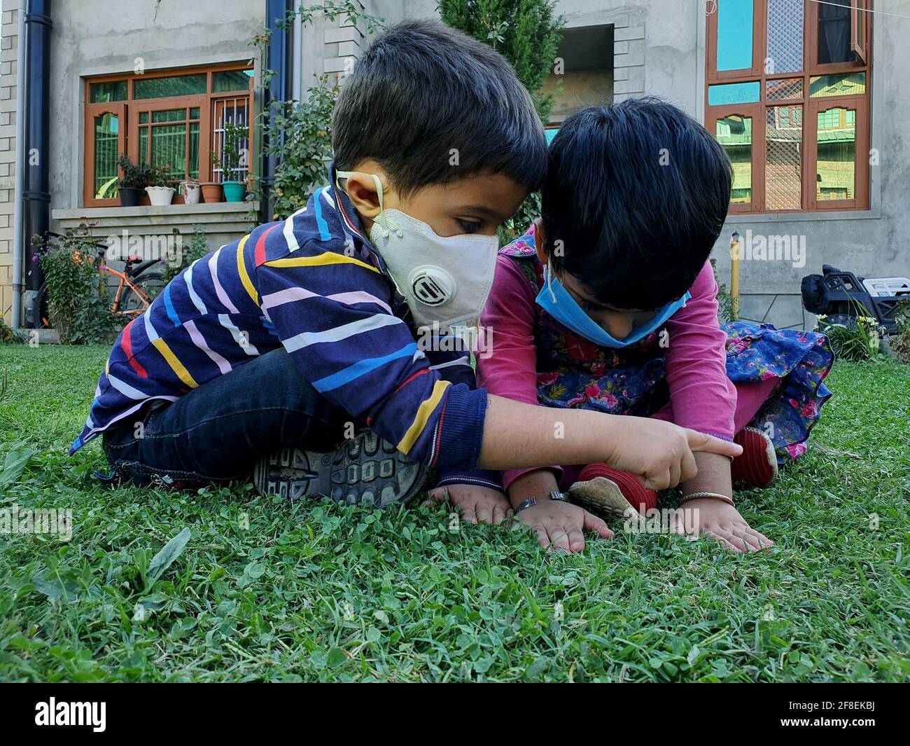 Masked kids playing Stock Photo - Alamy