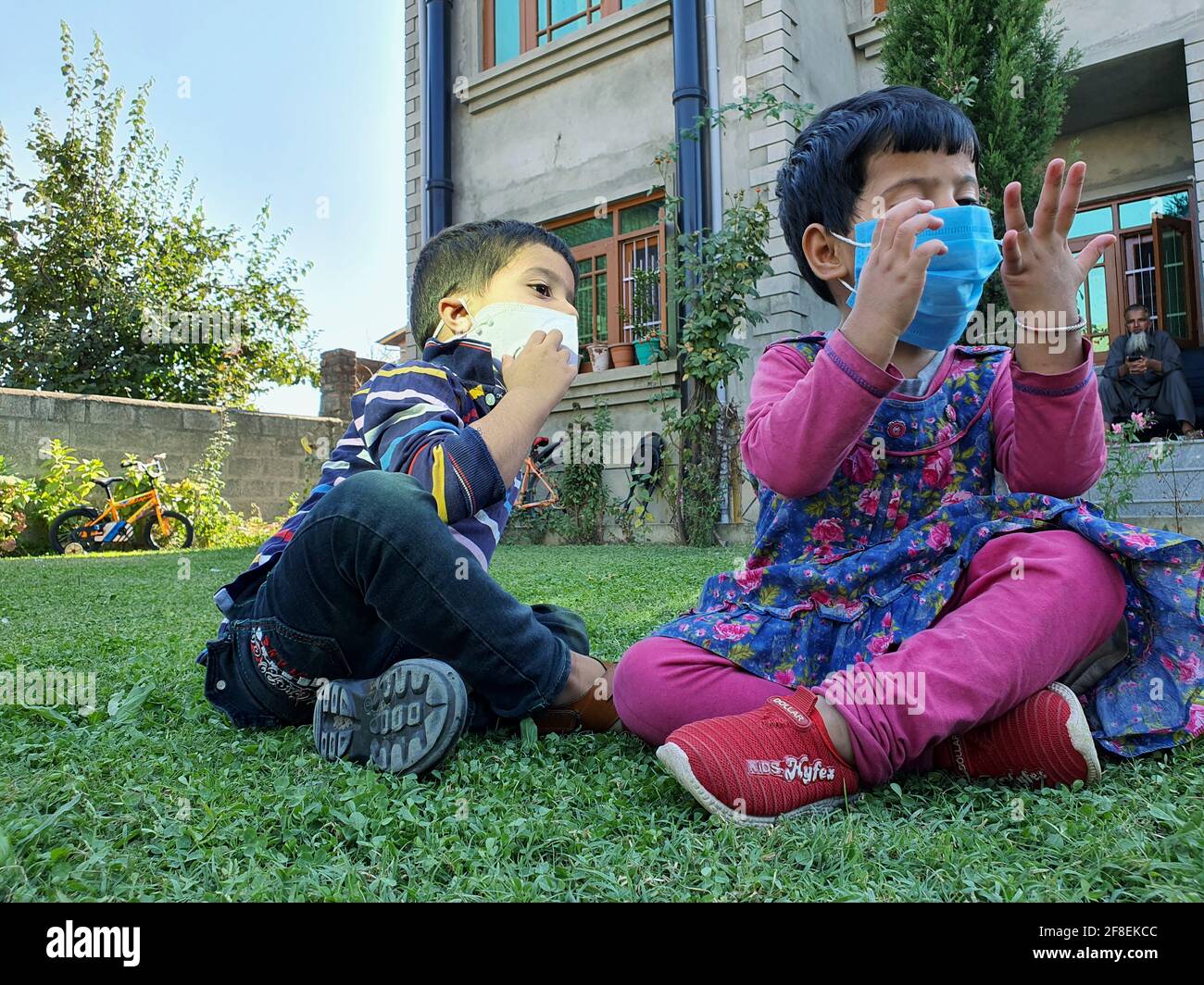 Masked kids playing Stock Photo - Alamy