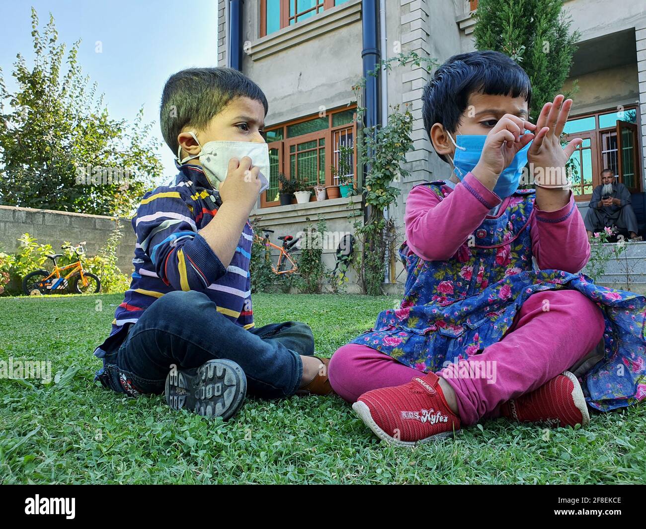 Masked kids playing Stock Photo - Alamy