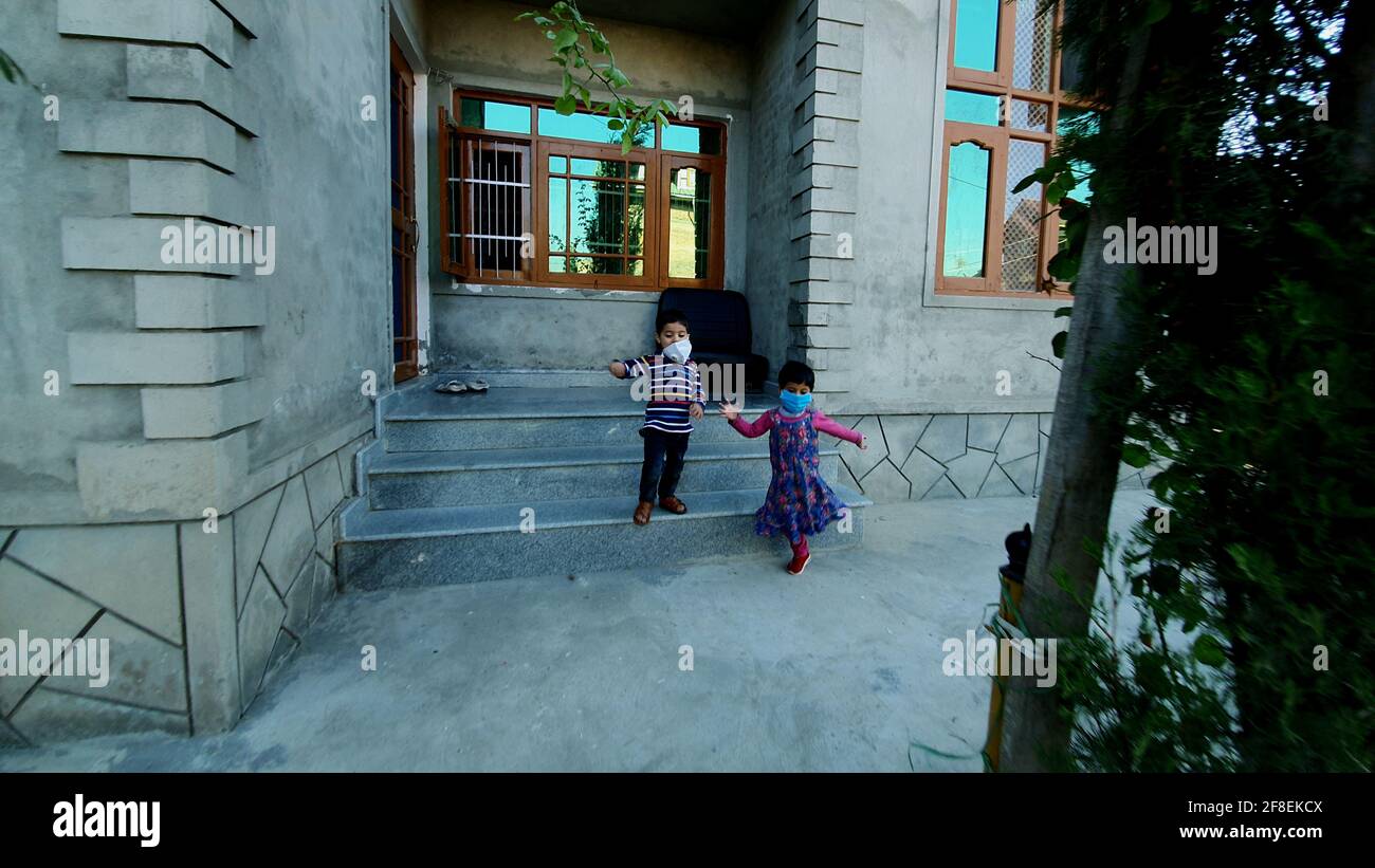 Masked kids playing Stock Photo - Alamy