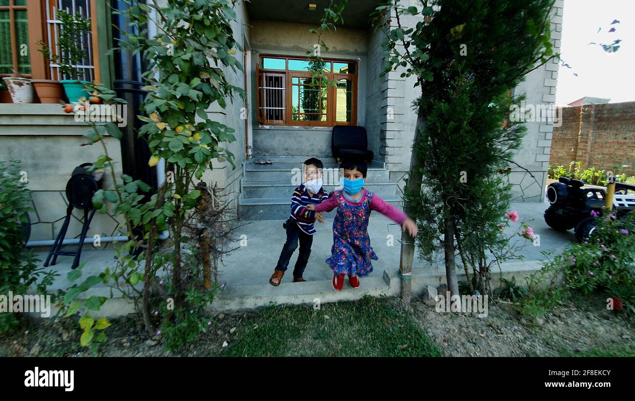 Masked kids playing Stock Photo - Alamy
